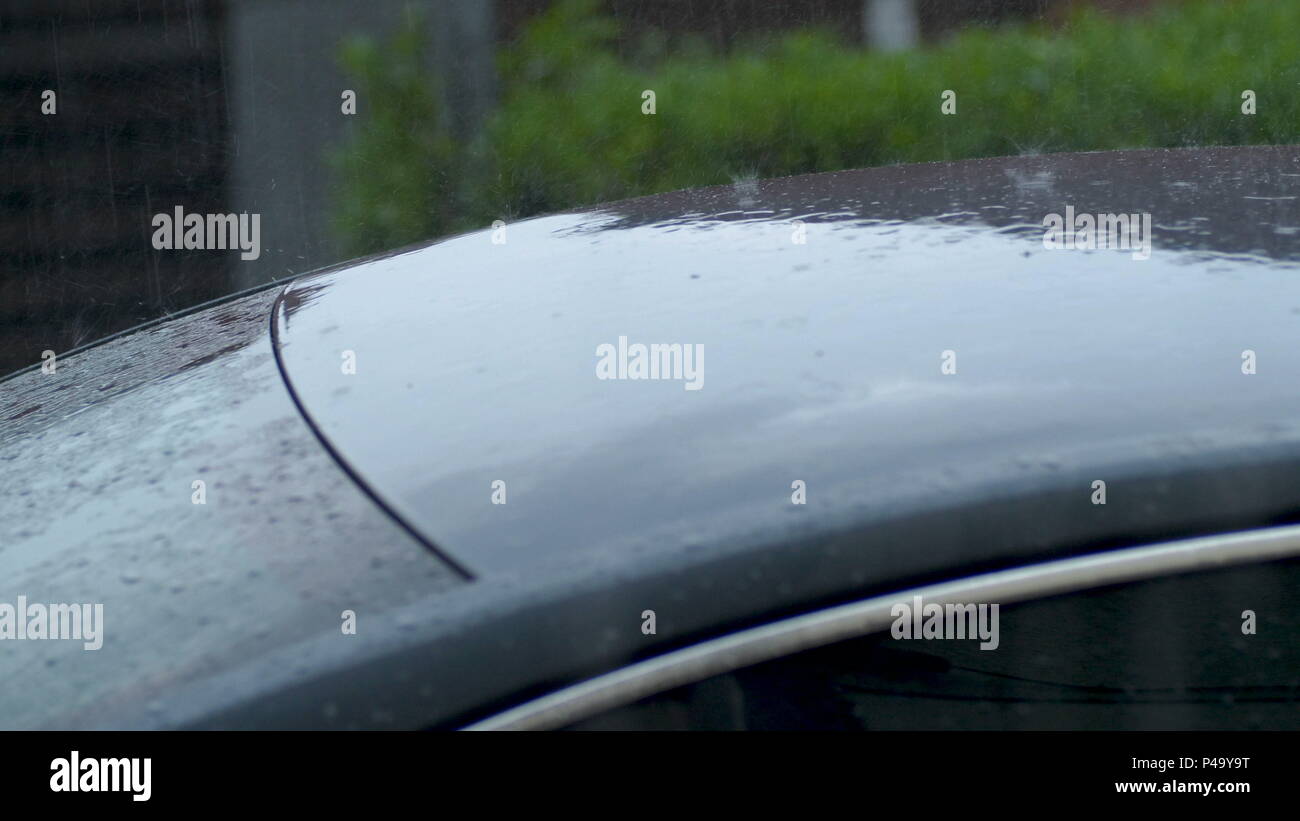 Large rain drops and hailstones strike parked cars during heavy shower in England Stock Photo ...