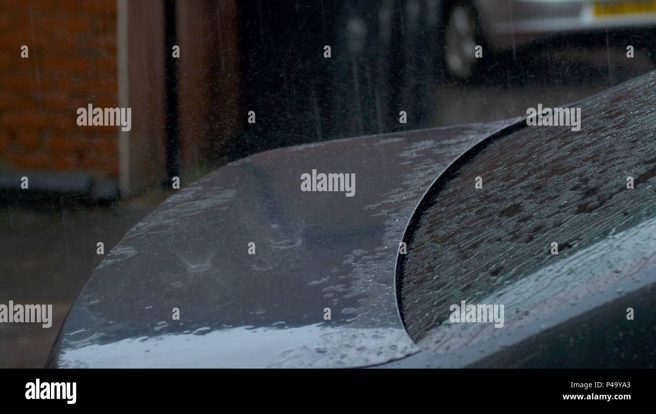 Large rain drops and hailstones strike parked cars during heavy shower in England Stock Photo ...