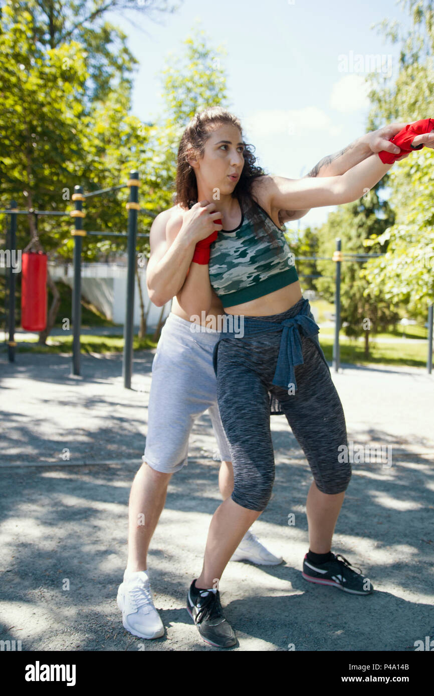 Boxer young man holding woman from behind, posing a boxing punch Stock ...