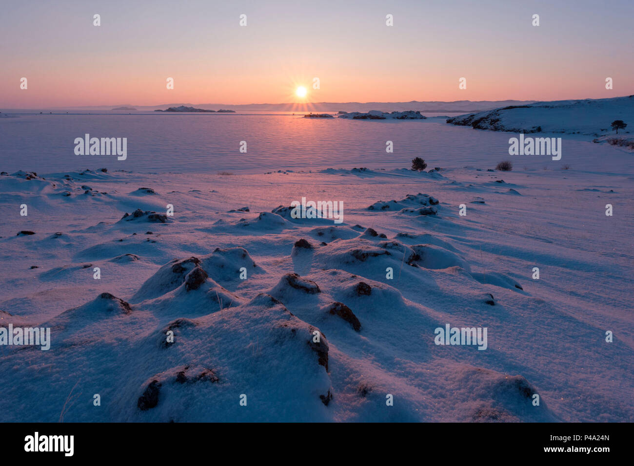 Rocks under the snow on Cape Uyuga at sunrise, Lake Baikal, Irkutsk ...