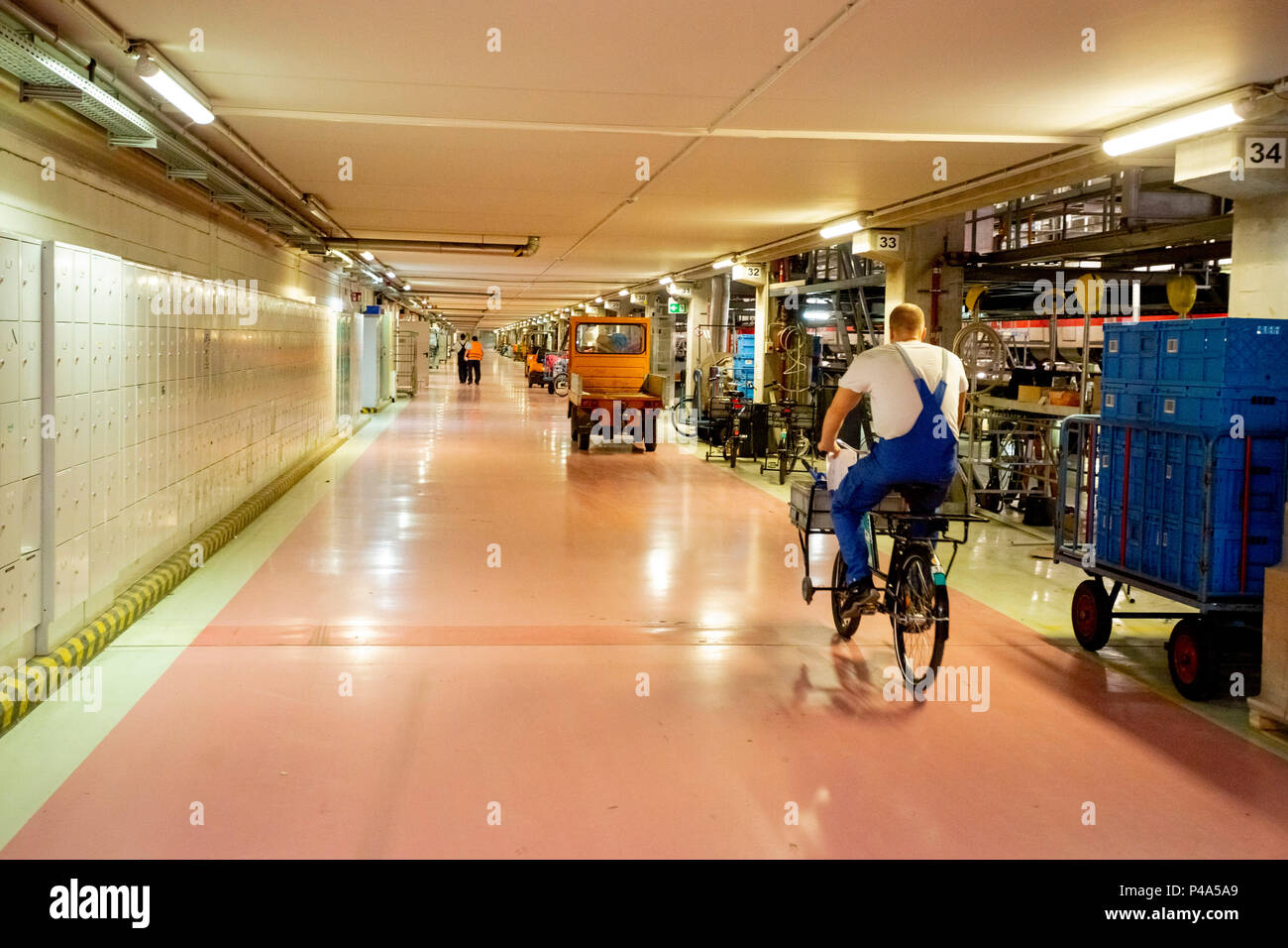 Berlin, Germany. 20th June, 2018. A warehouse worker cycling through a ...
