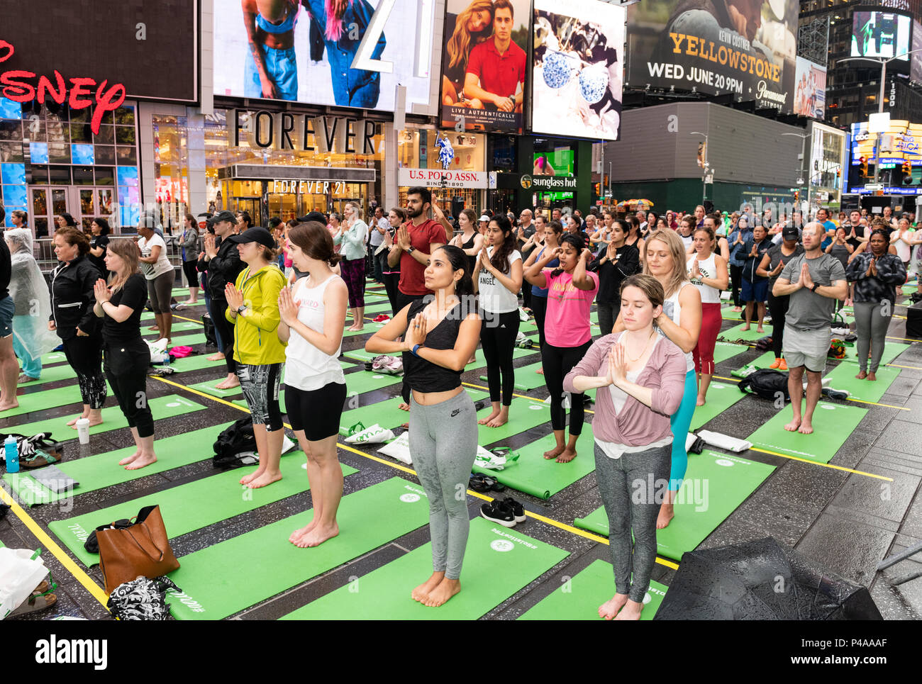 General view of people performing Yoga. Large yoga session in Times ...