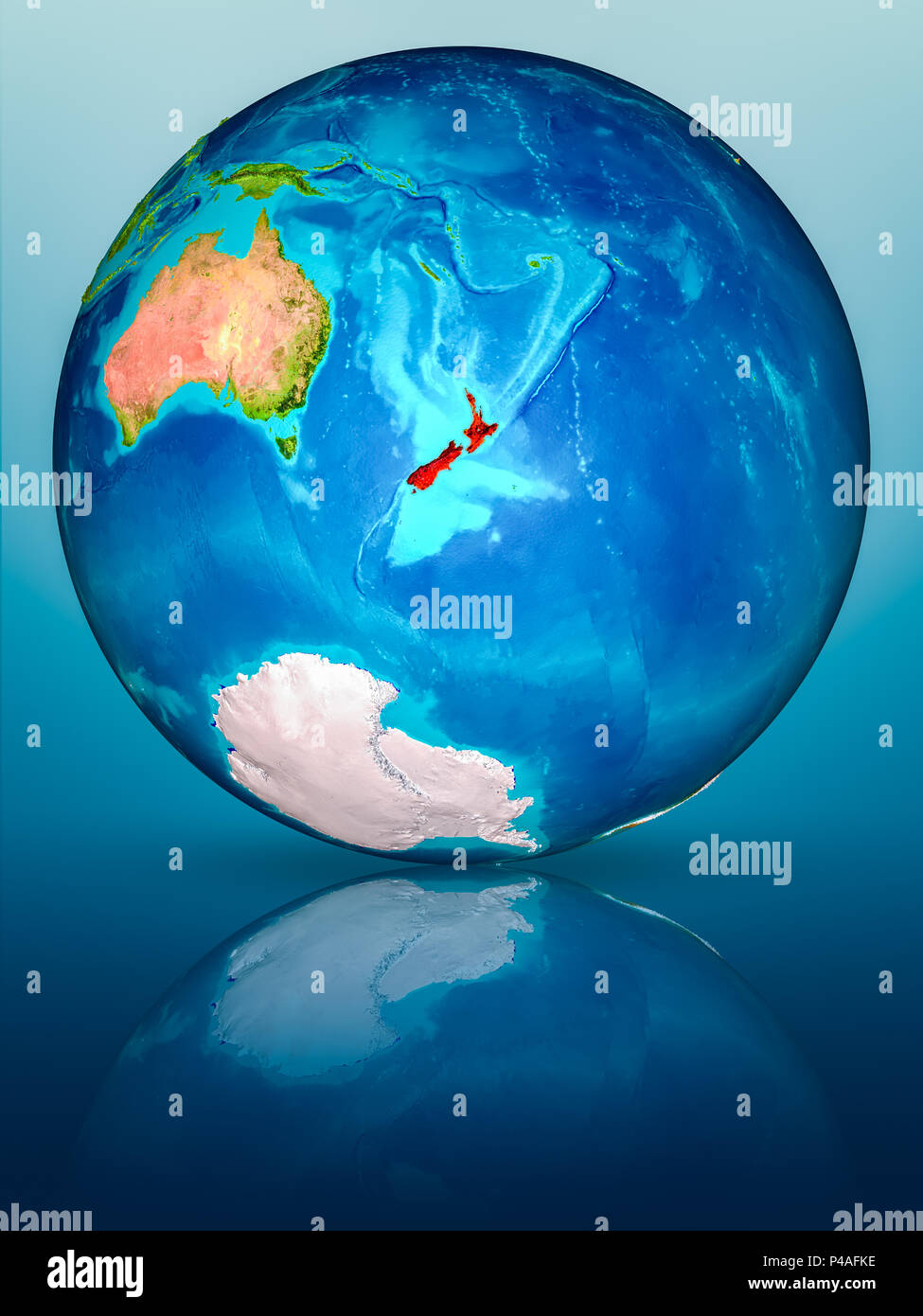 New Zealand in red on model of planet Earth on reflective blue surface ...