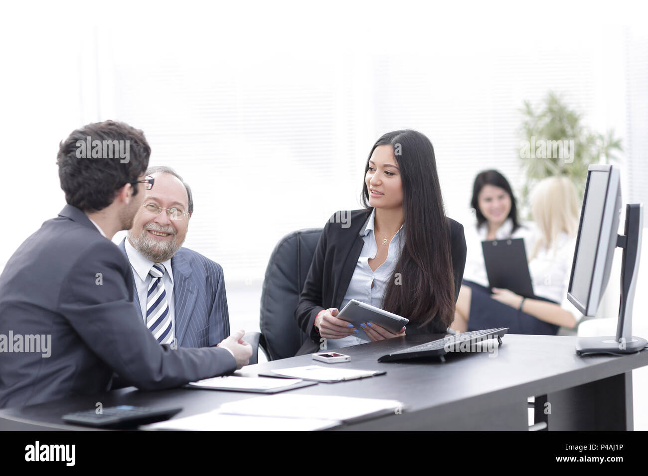 business colleagues at their Desk in the office .photo with place for ...