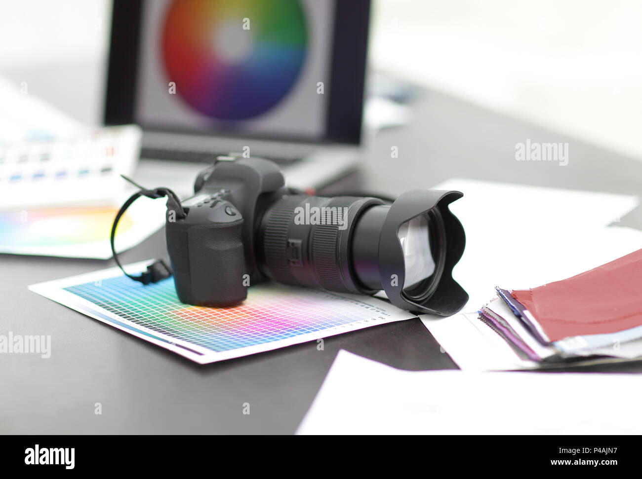 camera,fabric samples and sketches are on the desktop.camera,fabric ...