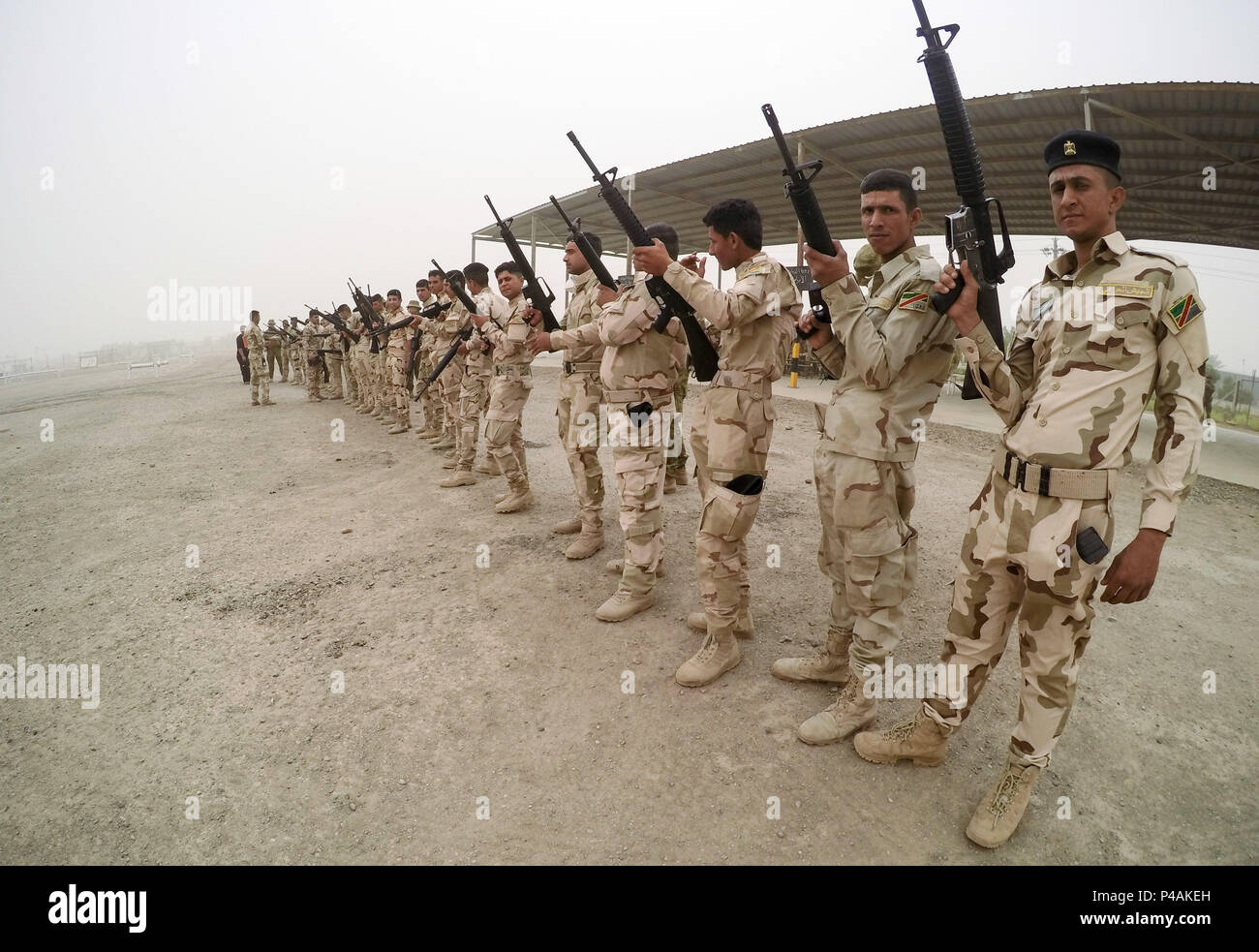 Iraqi soldiers with the 34 Armor Brigade point their weapons toward the ...