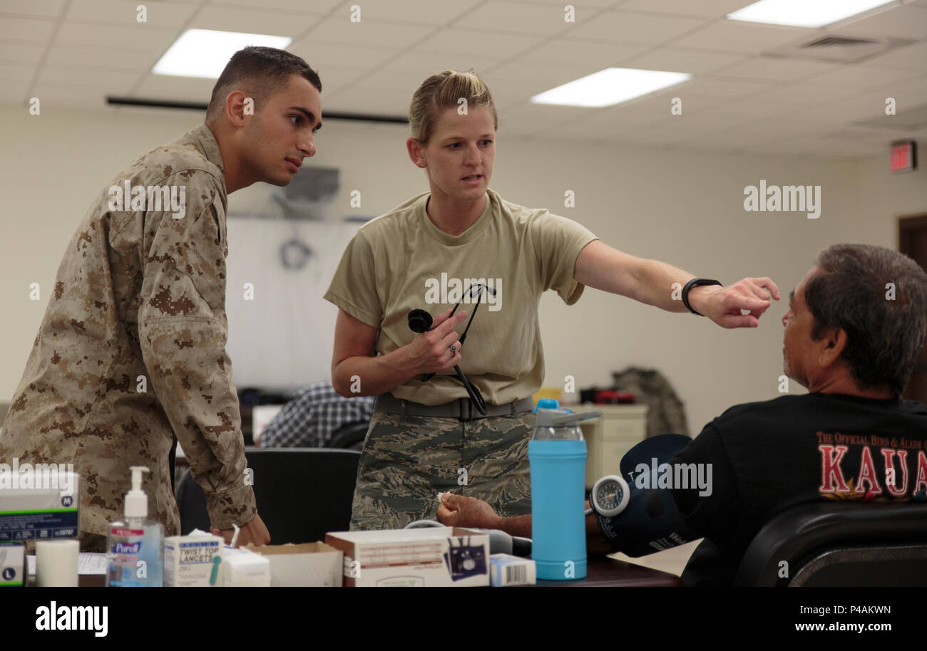 Lance Cpl. Alex A. Dossantos (left), a supply administration and ...