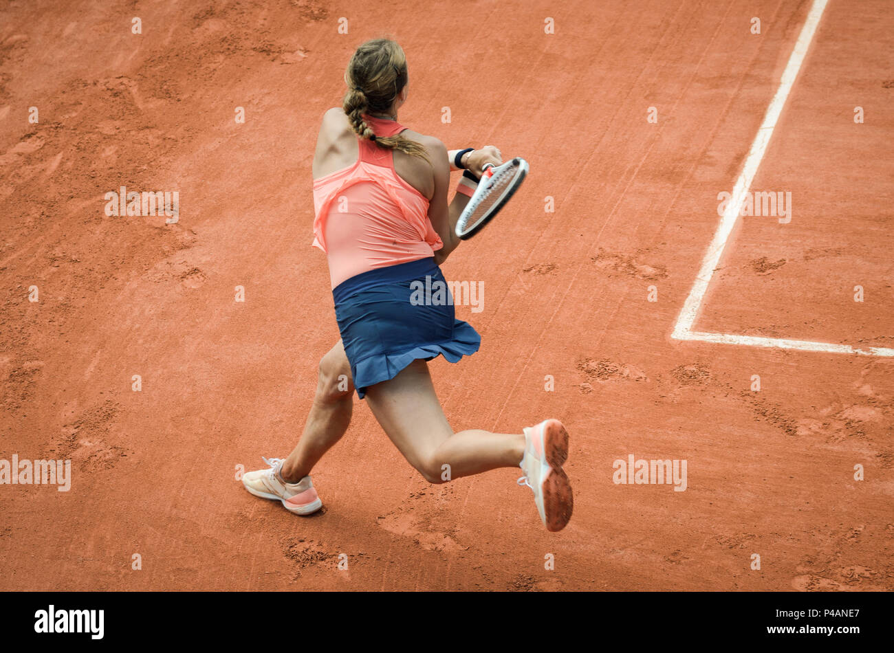 Back view of a woman playing backhand in tennis outdoor competition ...