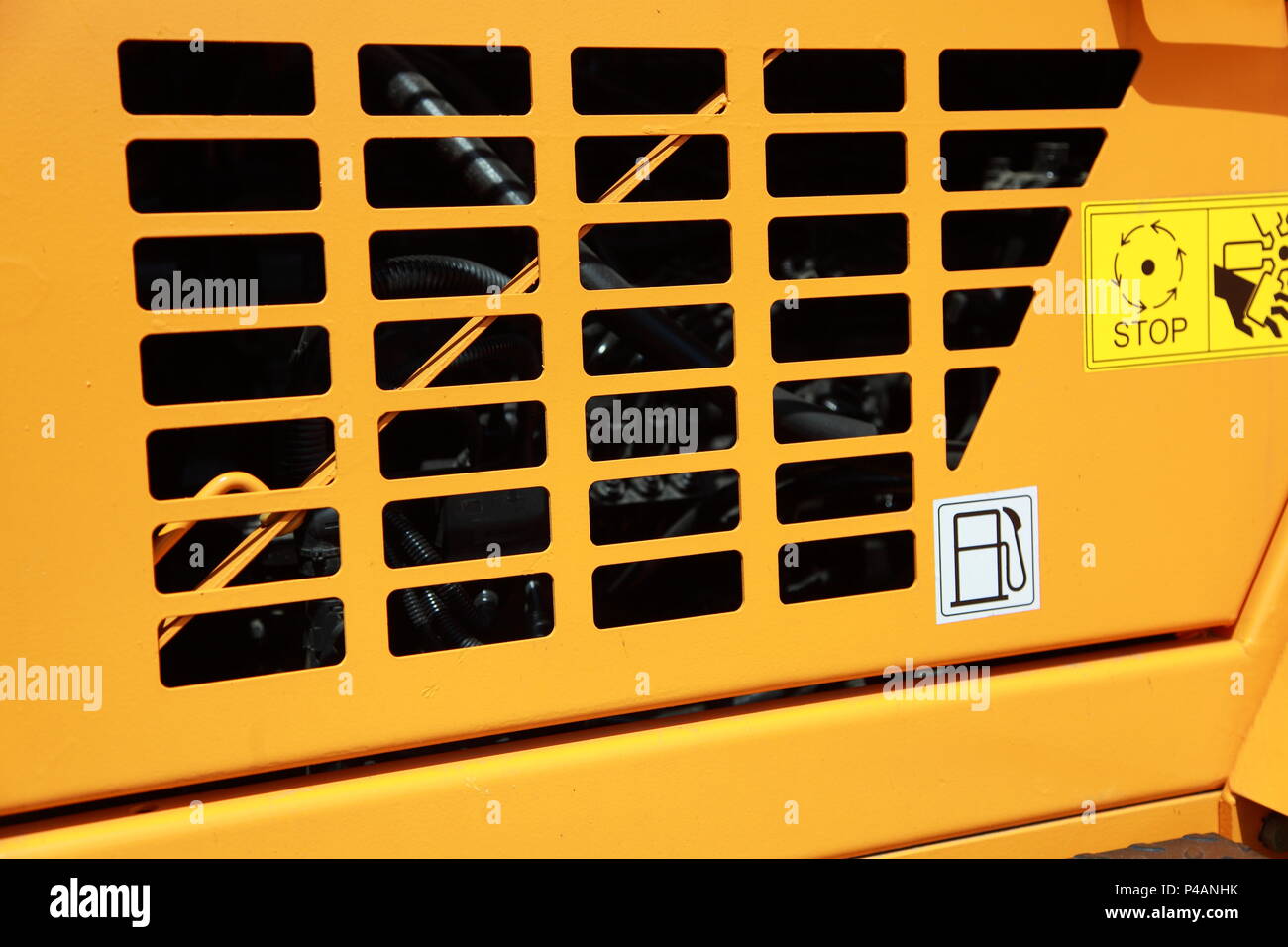 Orange grille of the new tractor's engine compartment Stock Photo - Alamy