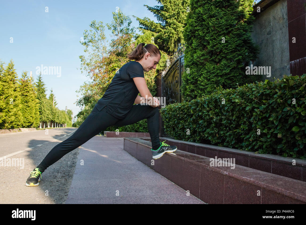 Young fitness woman runner stretching legs before run Stock Photo - Alamy