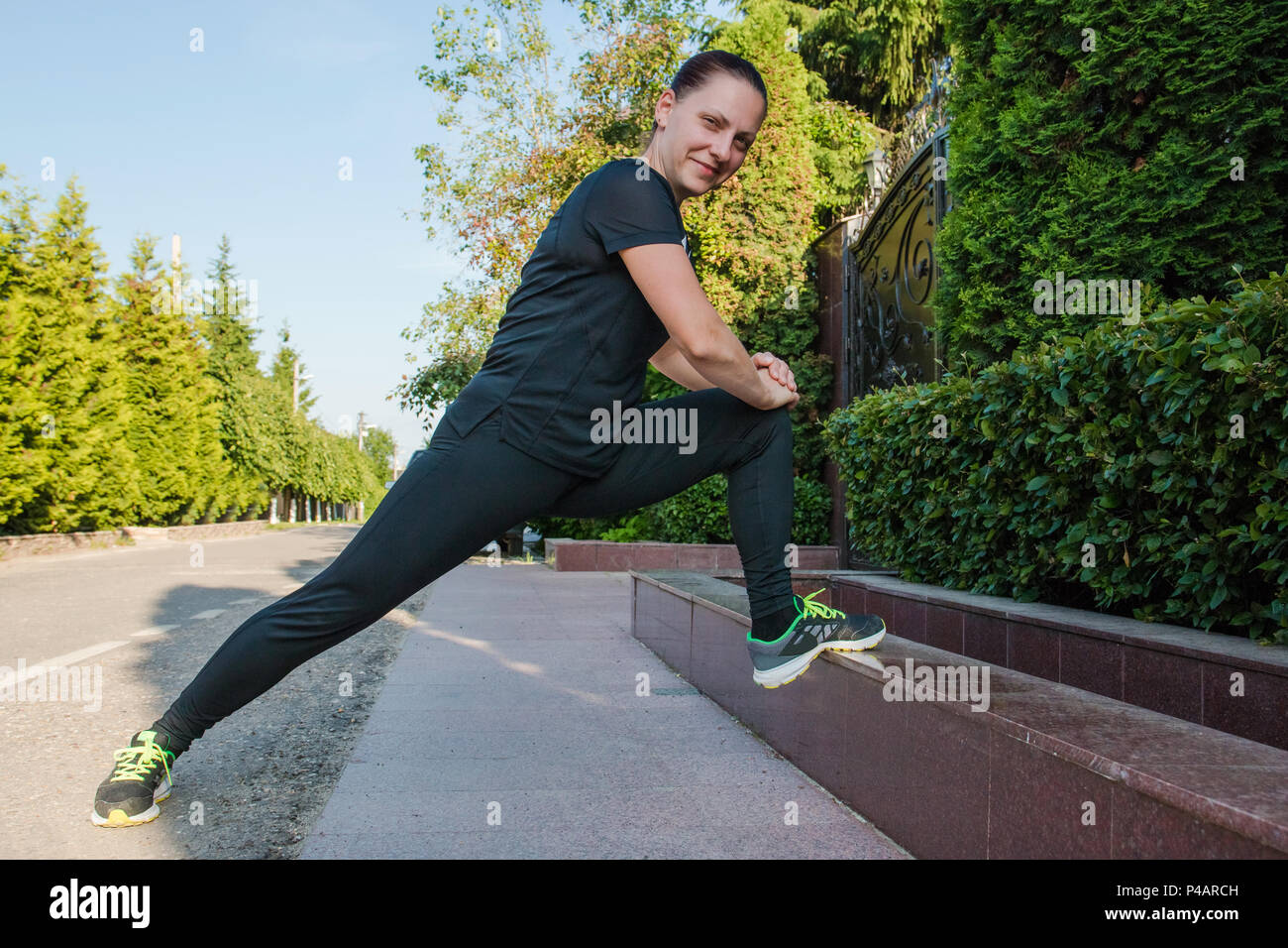 Young fitness woman runner stretching legs before run Stock Photo - Alamy