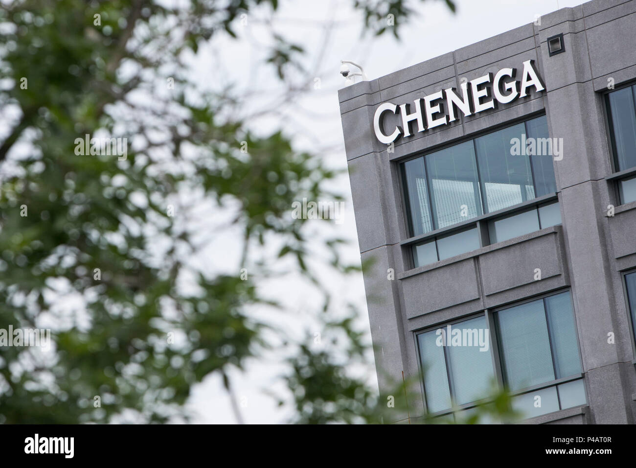 A logo sign outside of a facility occupied by the Chenega Corporation ...