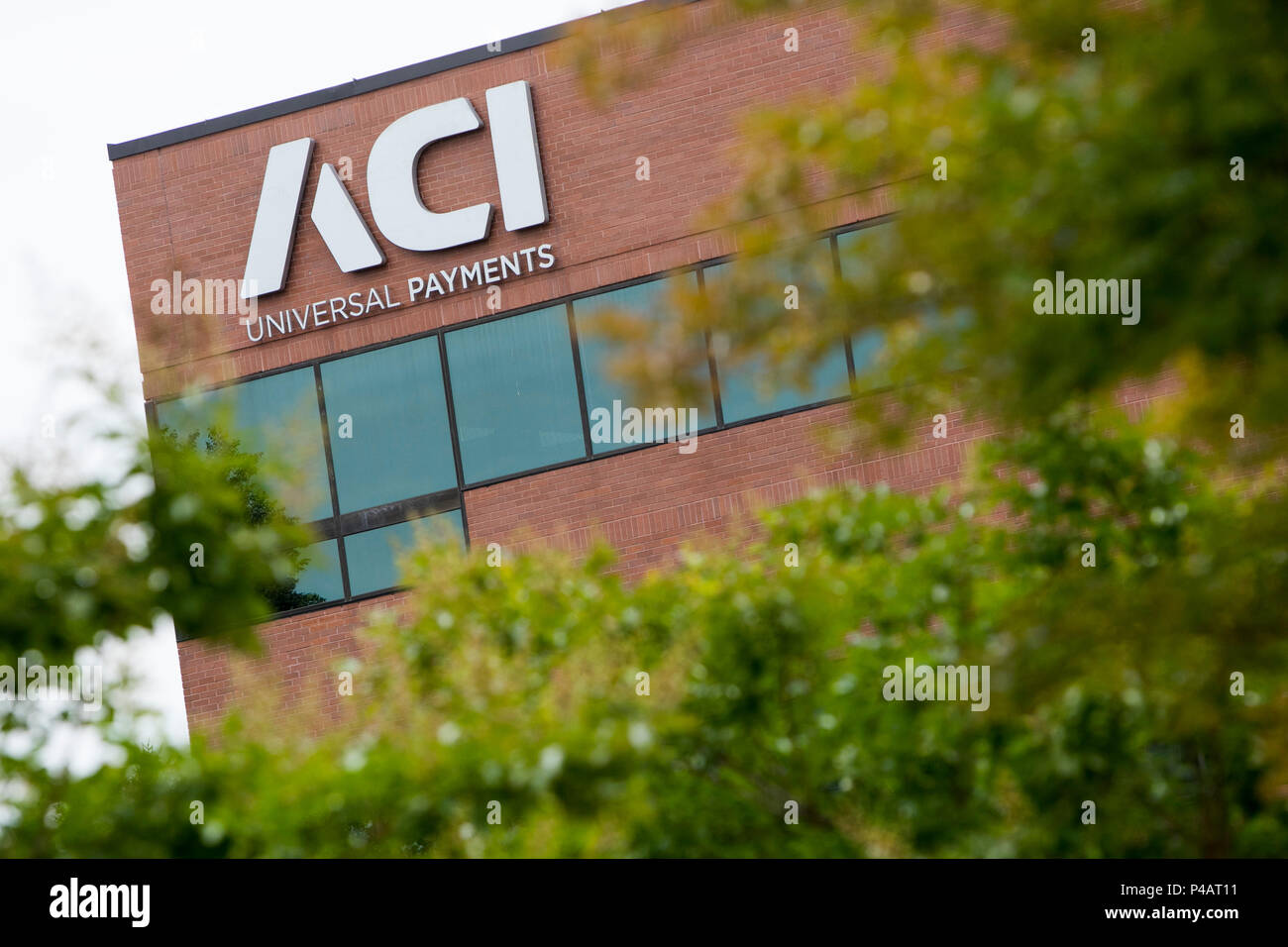 A logo sign outside of a facility occupied by ACI Worldwide Inc., in ...