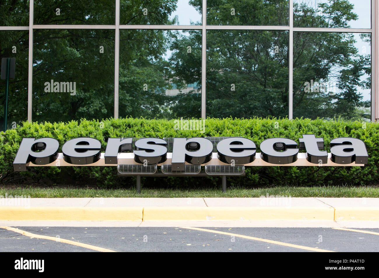 A logo sign outside of a facility occupied by Perspecta in Chantilly ...