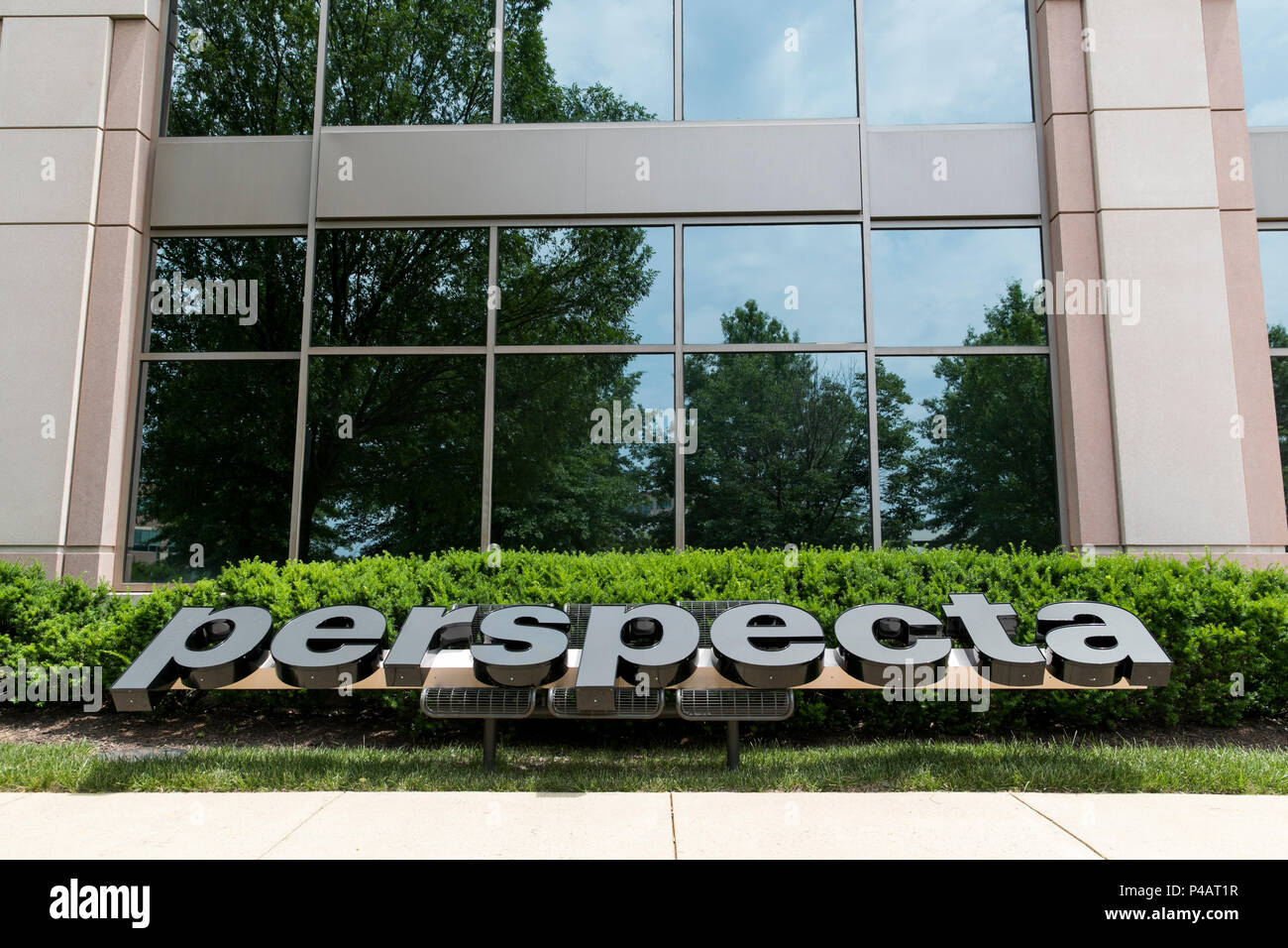 A logo sign outside of a facility occupied by Perspecta in Chantilly ...
