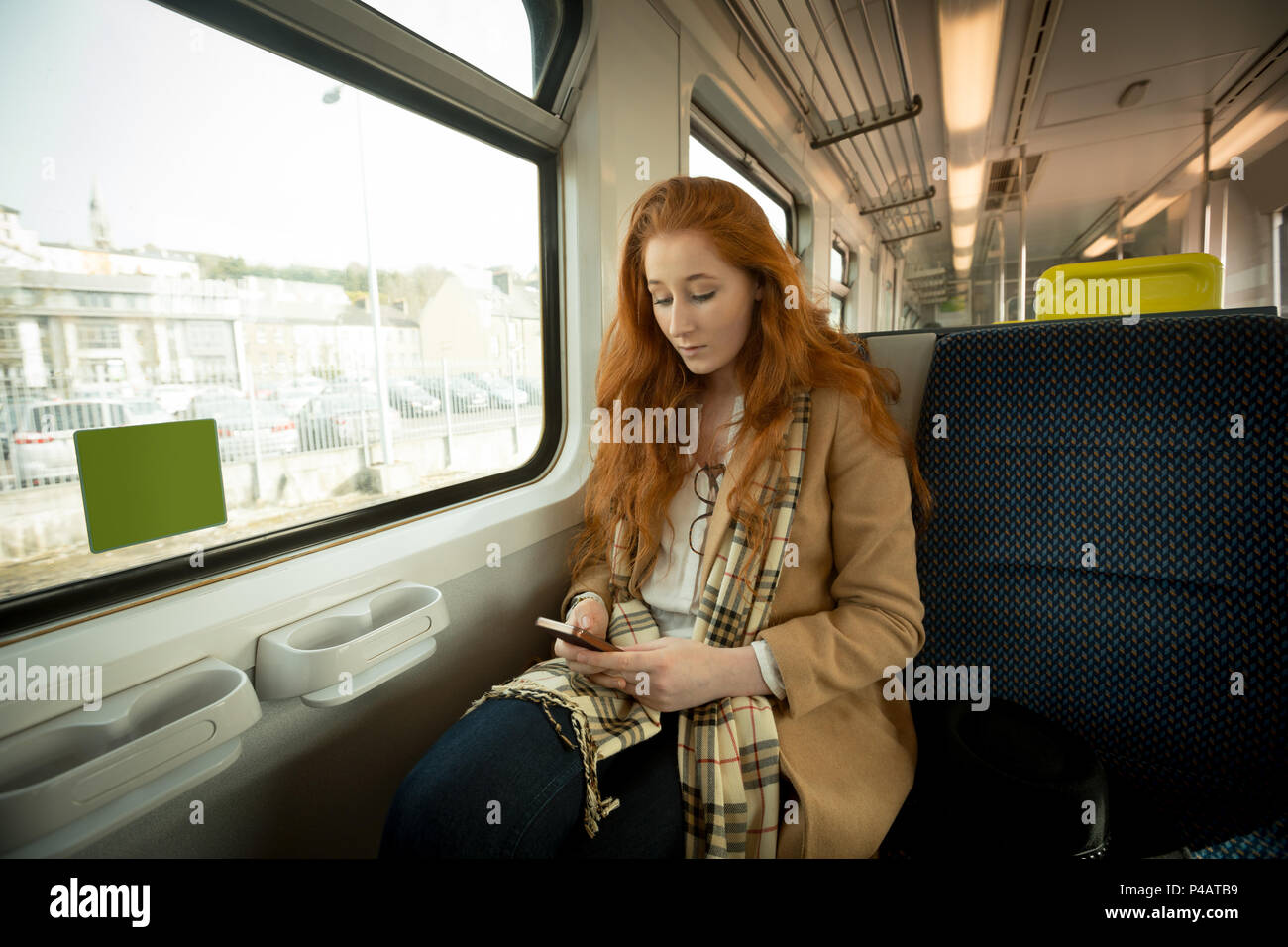 Woman using cellphone in train hi-res stock photography and images - Alamy