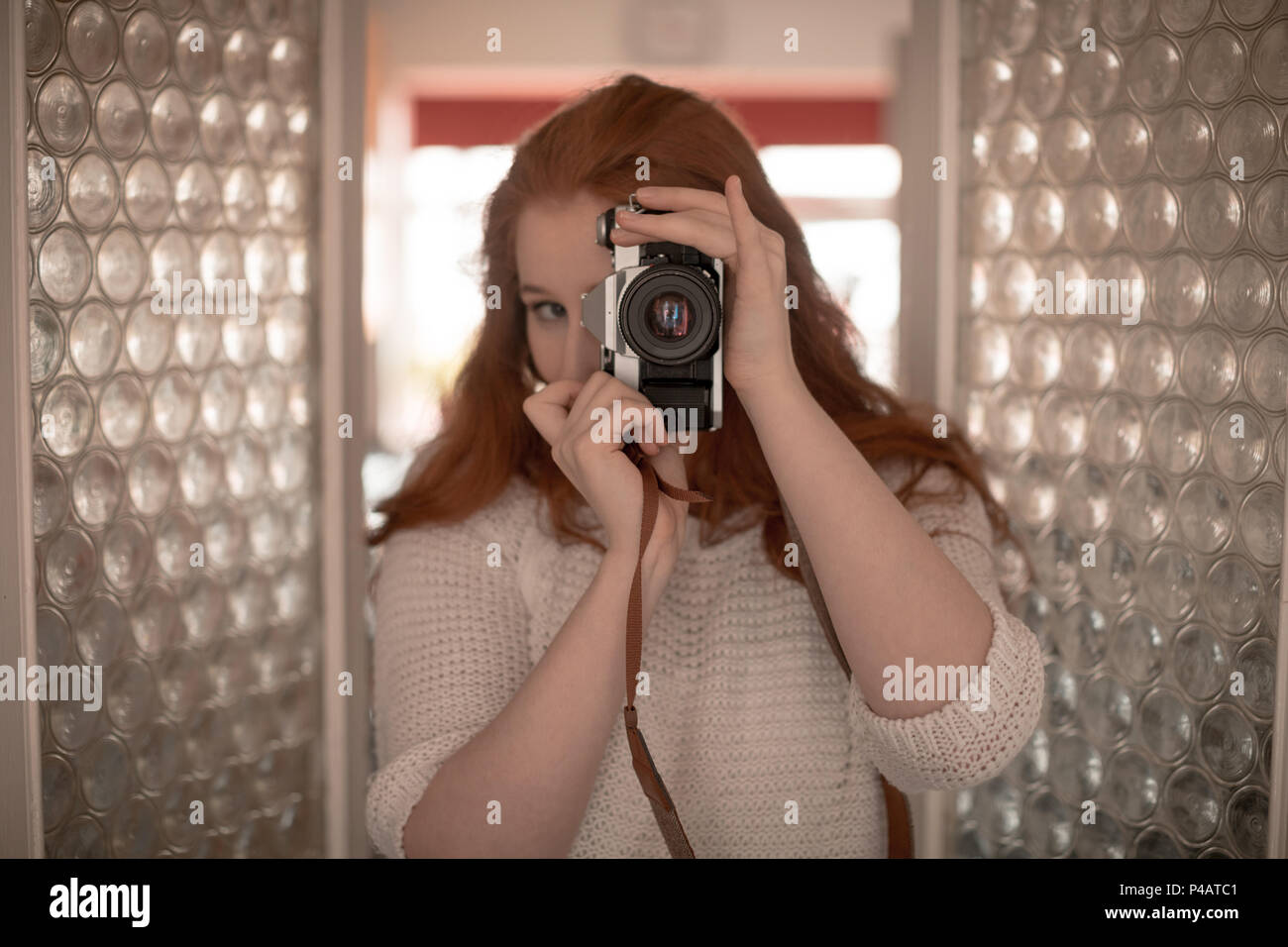 Woman clicking photo with camera Stock Photo - Alamy