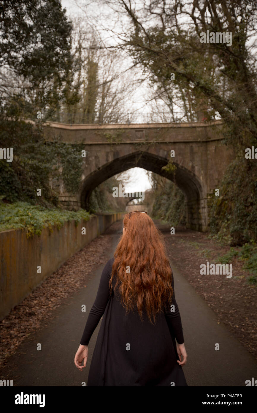 Woman walking on a countryside road Stock Photo - Alamy
