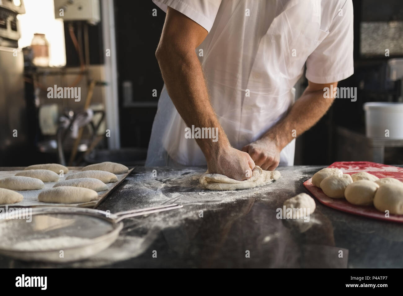 Male baker preparing dough in bakery shop Stock Photo - Alamy
