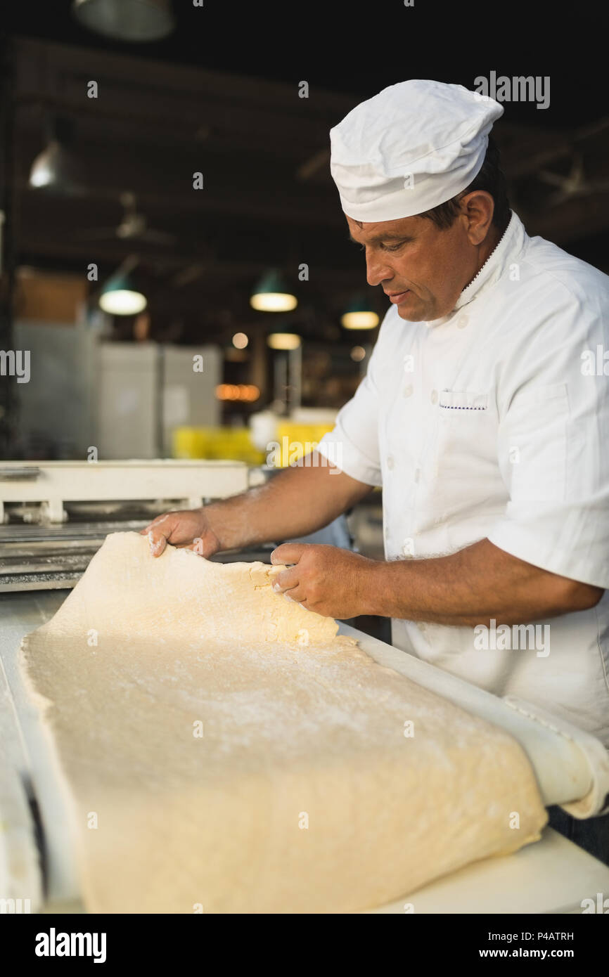 Male baker working in baker shop Stock Photo - Alamy