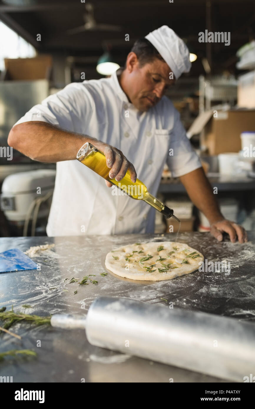 Man pouring oil hi-res stock photography and images - Alamy
