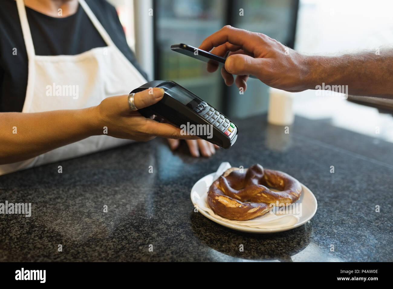 Customer making payment through mobile phone Stock Photo - Alamy