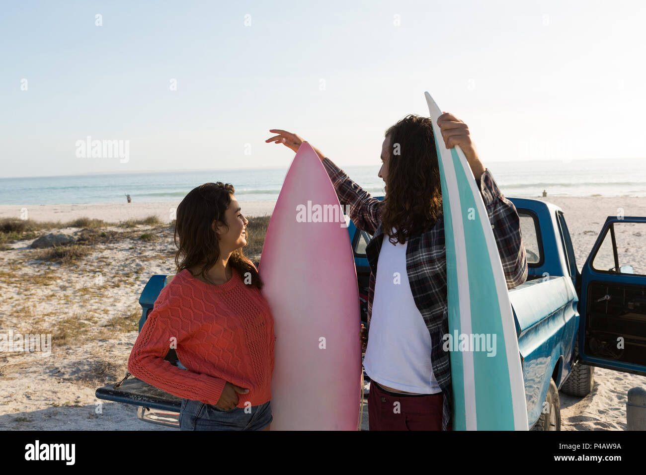 Couple interacting with each other in the beach Stock Photo - Alamy