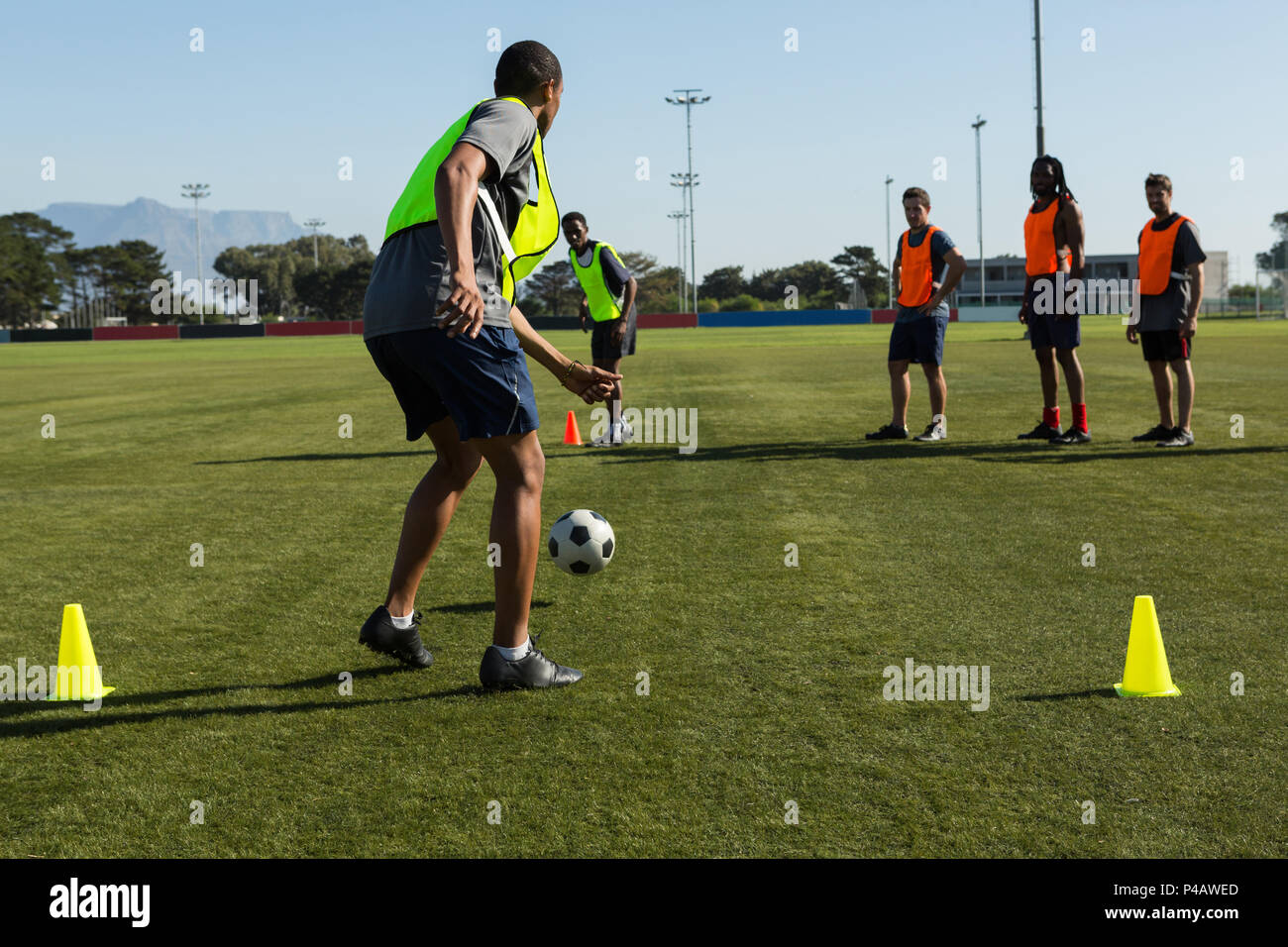 Players practicing soccer in the field Stock Photo - Alamy