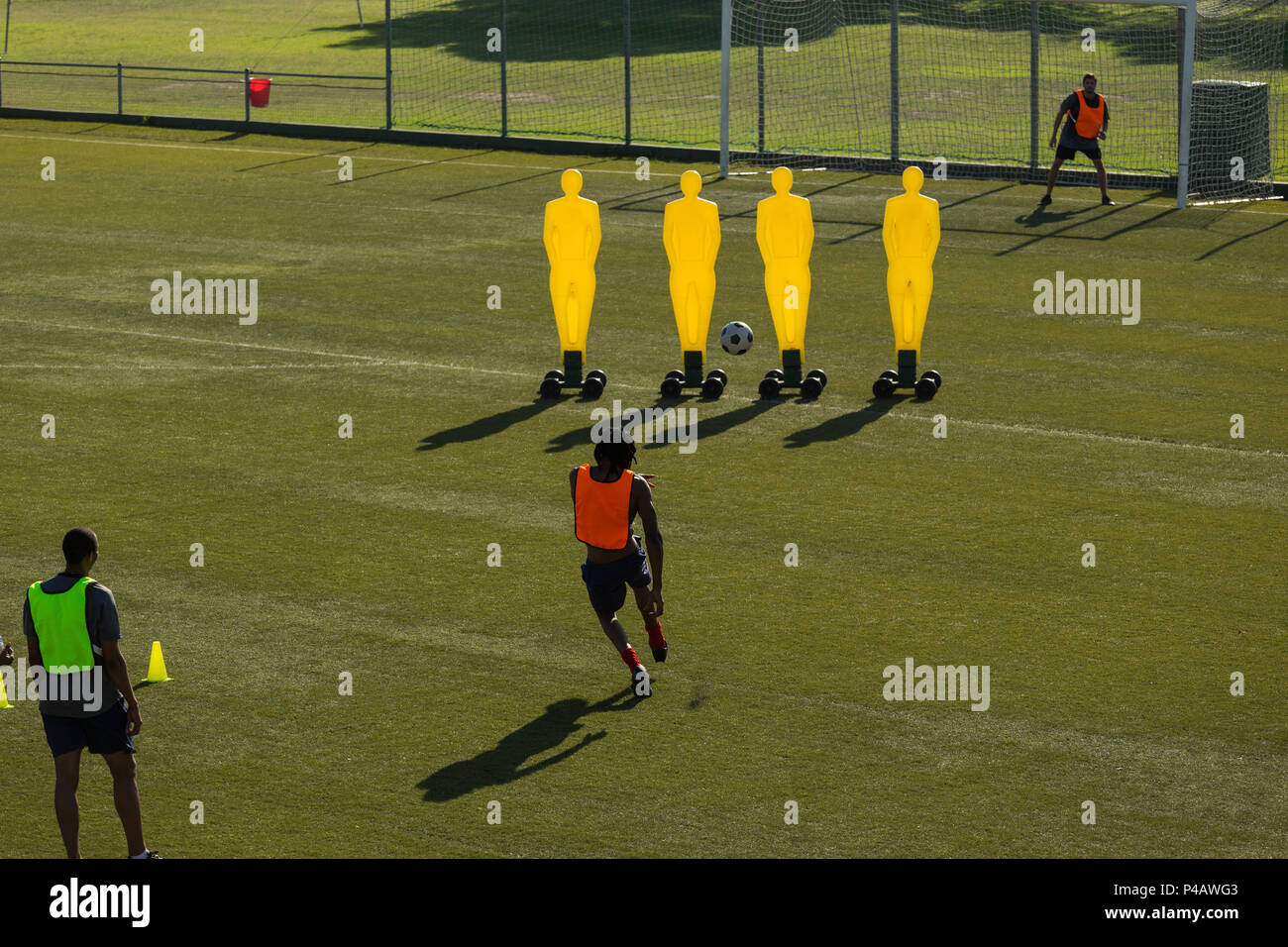 Players practicing football in field Stock Photo - Alamy
