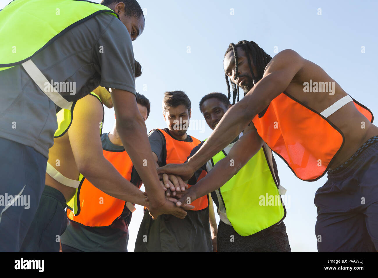 Football team holding hands together before game Stock Photo - Alamy