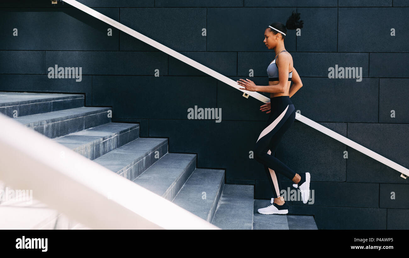 Woman running upstairs hi-res stock photography and images - Alamy