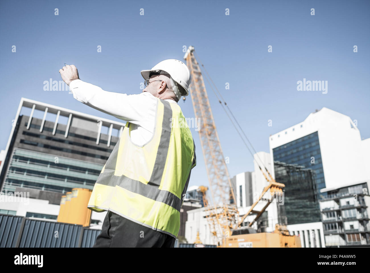 Senior foreman in glasses doing his job at building area on sunn Stock ...