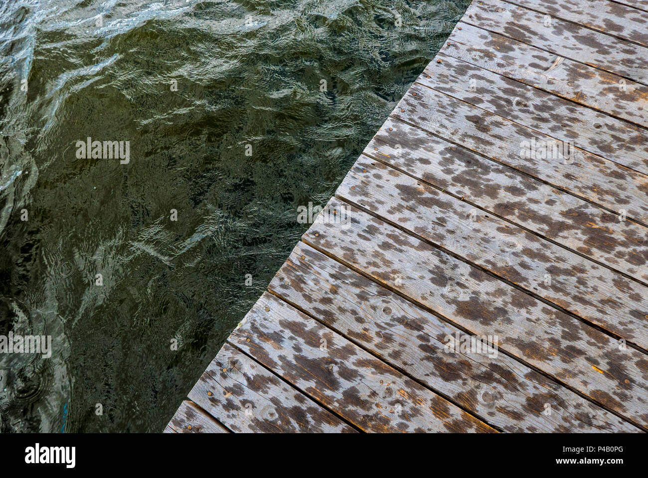 Rain drops begin to dampen boat dock, Dore Lake, Saskatchewan, Canada ...