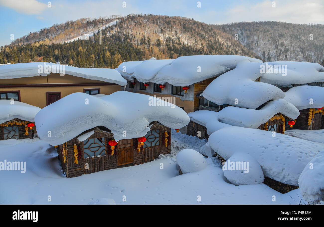 Wooden houses covered by snow at mountain village in Harbin, China ...