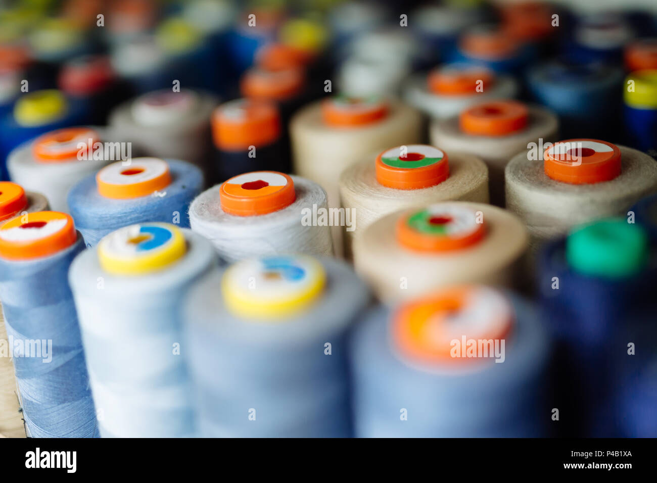 Colorful thread spools used in fabric industry Stock Photo - Alamy