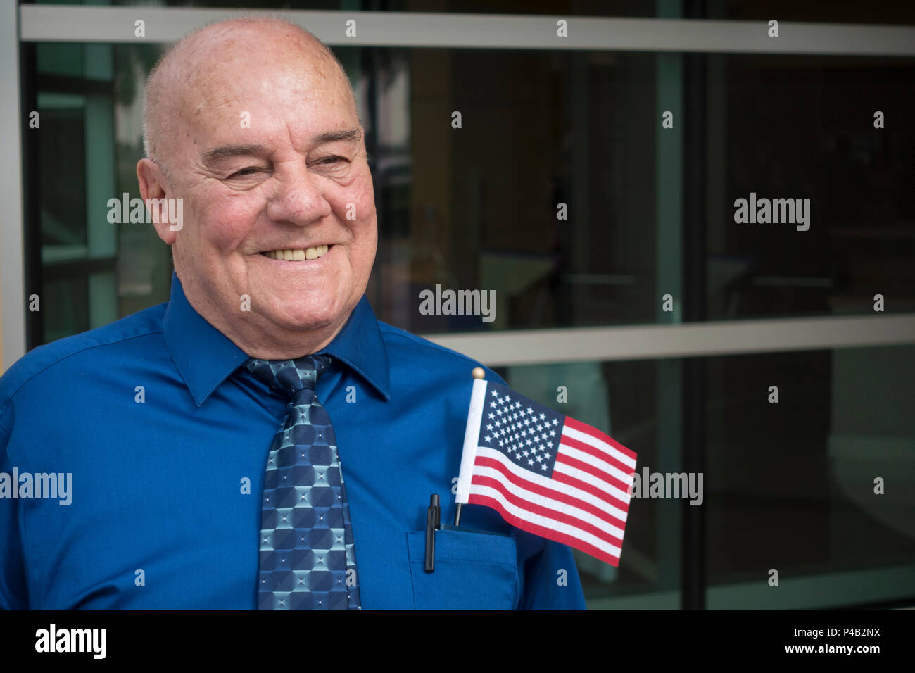 Just sworn in as American Citizens, immigrants wave flags and hold ...