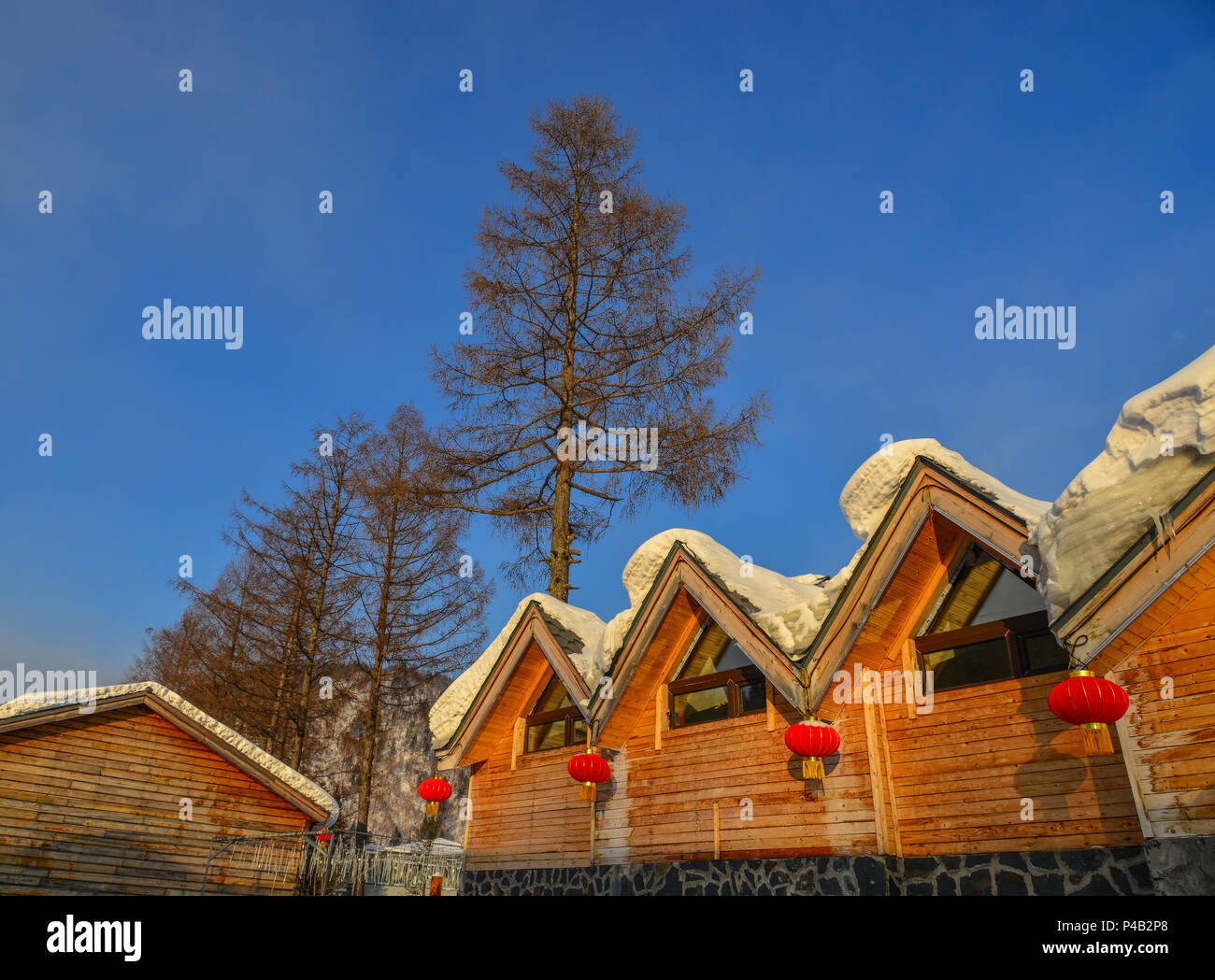Wooden house covered by snow at mountain town in Mohe County, China ...