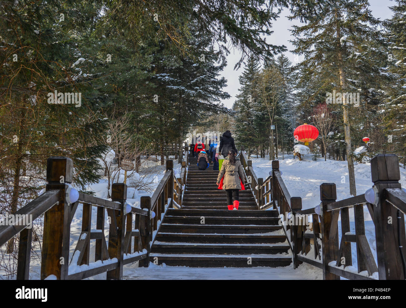 Harbin, China - Feb 24, 2018. People walking on wooden bridge of nature ...