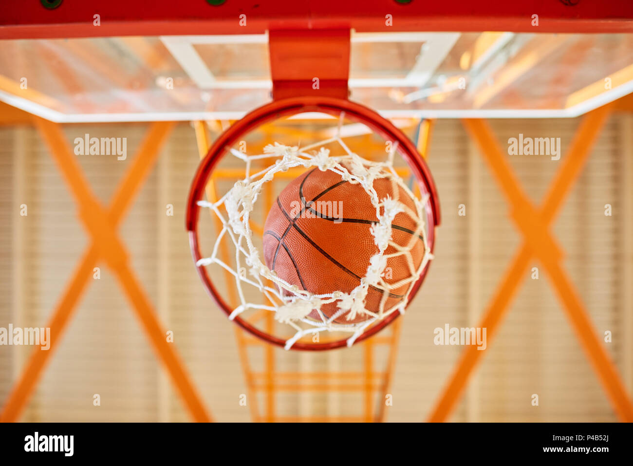 Ball falling through basketball basket Stock Photo - Alamy