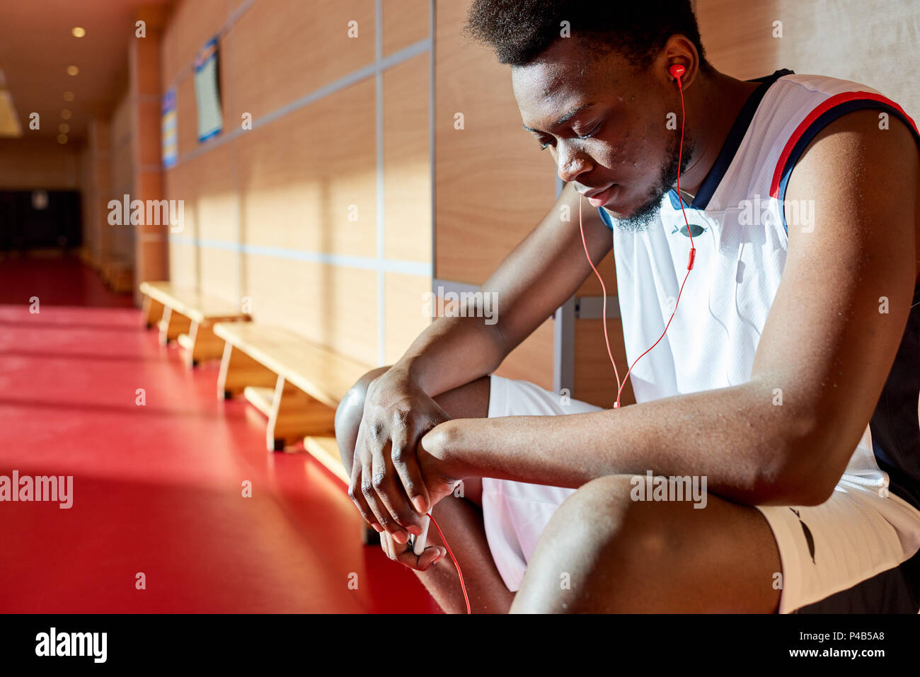 Basketball player listening to music Stock Photo - Alamy