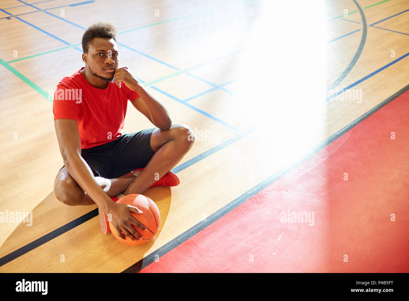 Man sitting basketball ball hi-res stock photography and images - Alamy