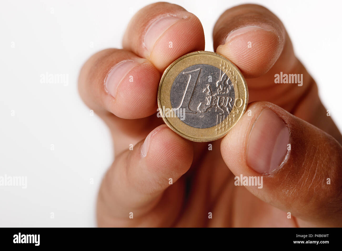 man's hand holding euro coin Stock Photo - Alamy