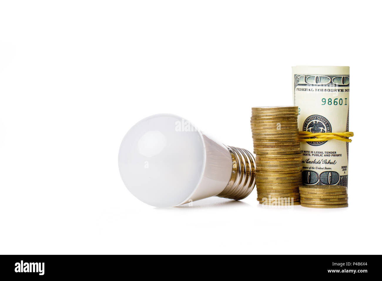LED bulb and coins Stock Photo - Alamy