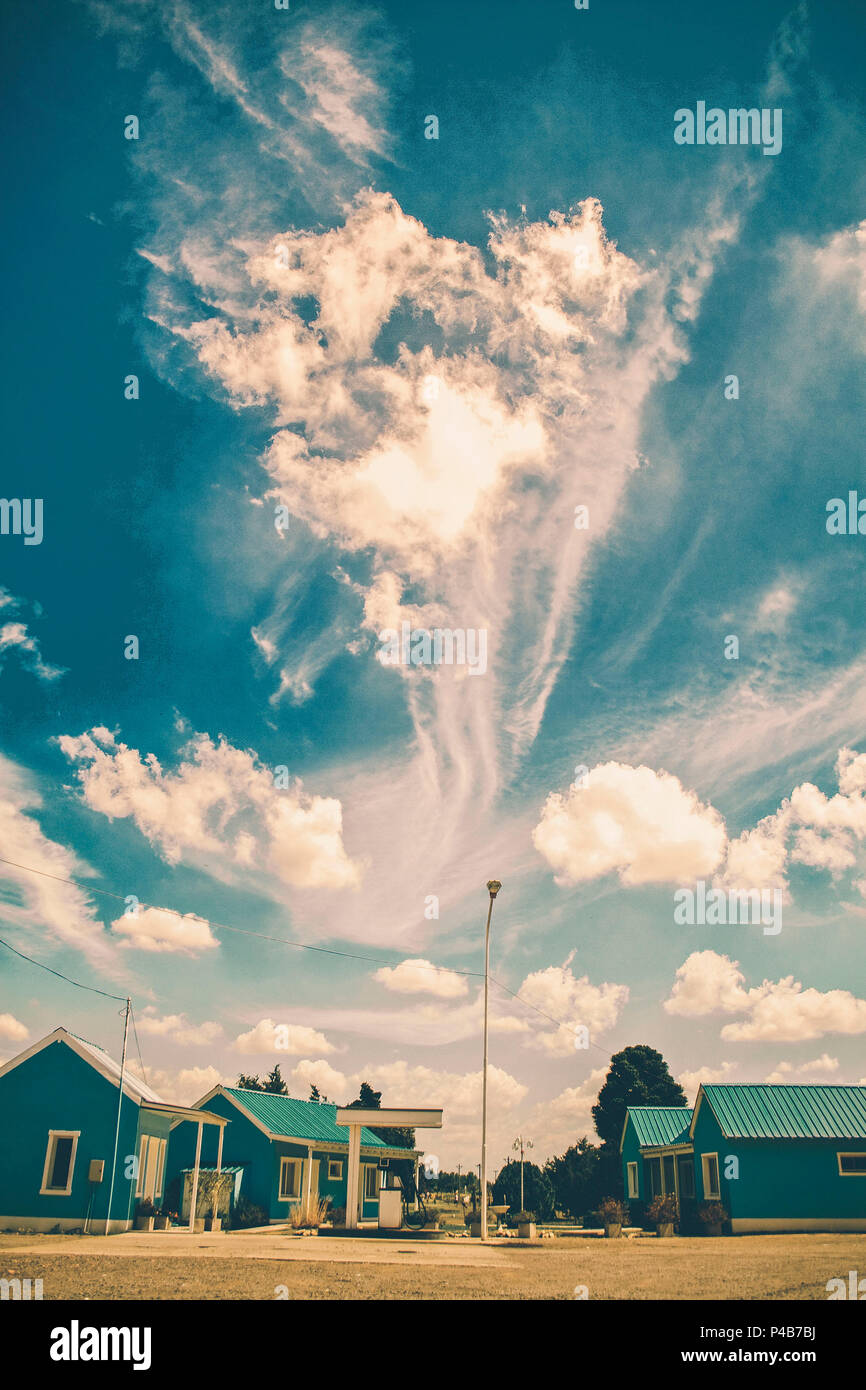 Clouds with cone shape close to blue houses hi-res stock photography ...