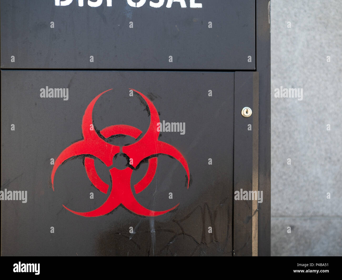 A biohazard spray painted logo on an outdoor steel container with copy ...
