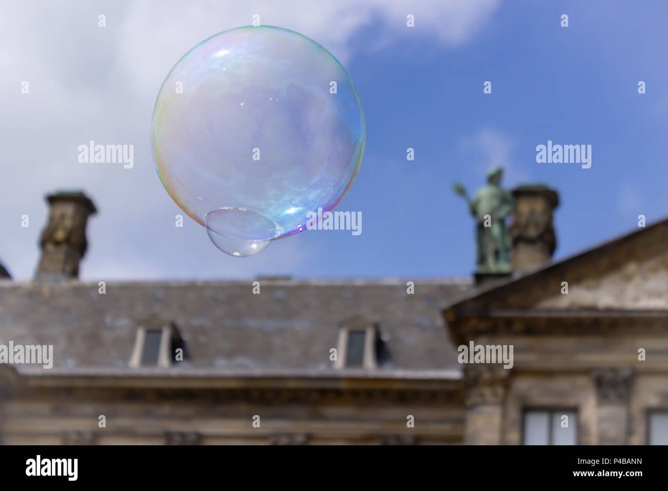 Bubbles float through the sky above Dam Square, Amsterdam, Netherlands ...