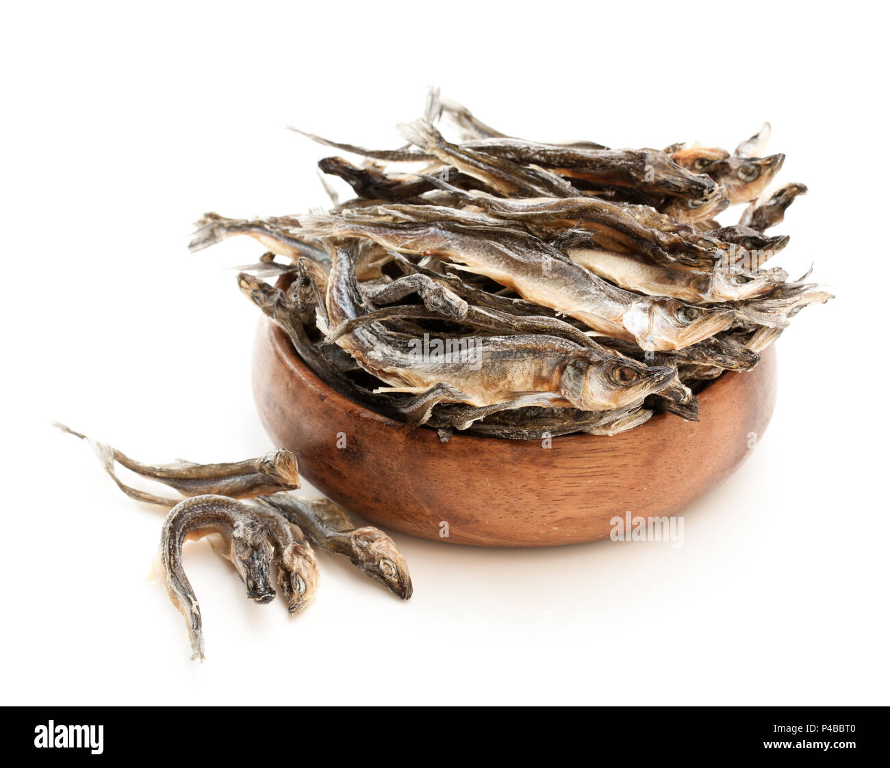 Dried fishes in wooden bowl isolated on white Stock Photo - Alamy