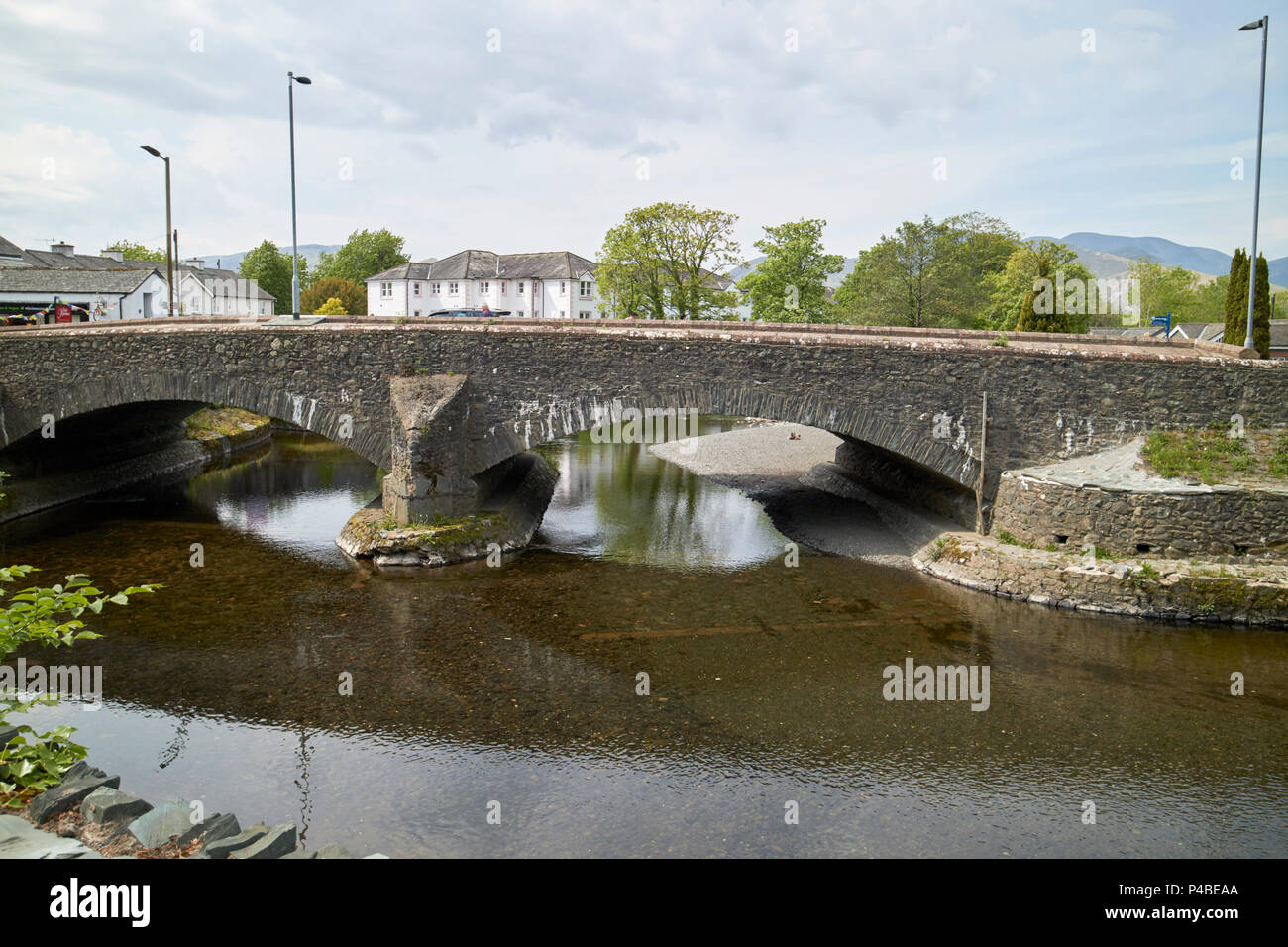 old stone bridge over the river Greta in Keswick Lake District Cumbria ...