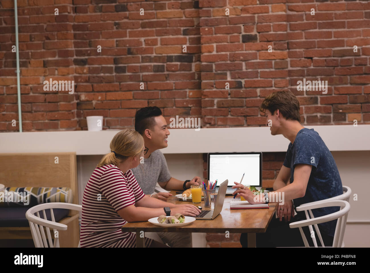 Executives discussing with each other in the creative office Stock ...