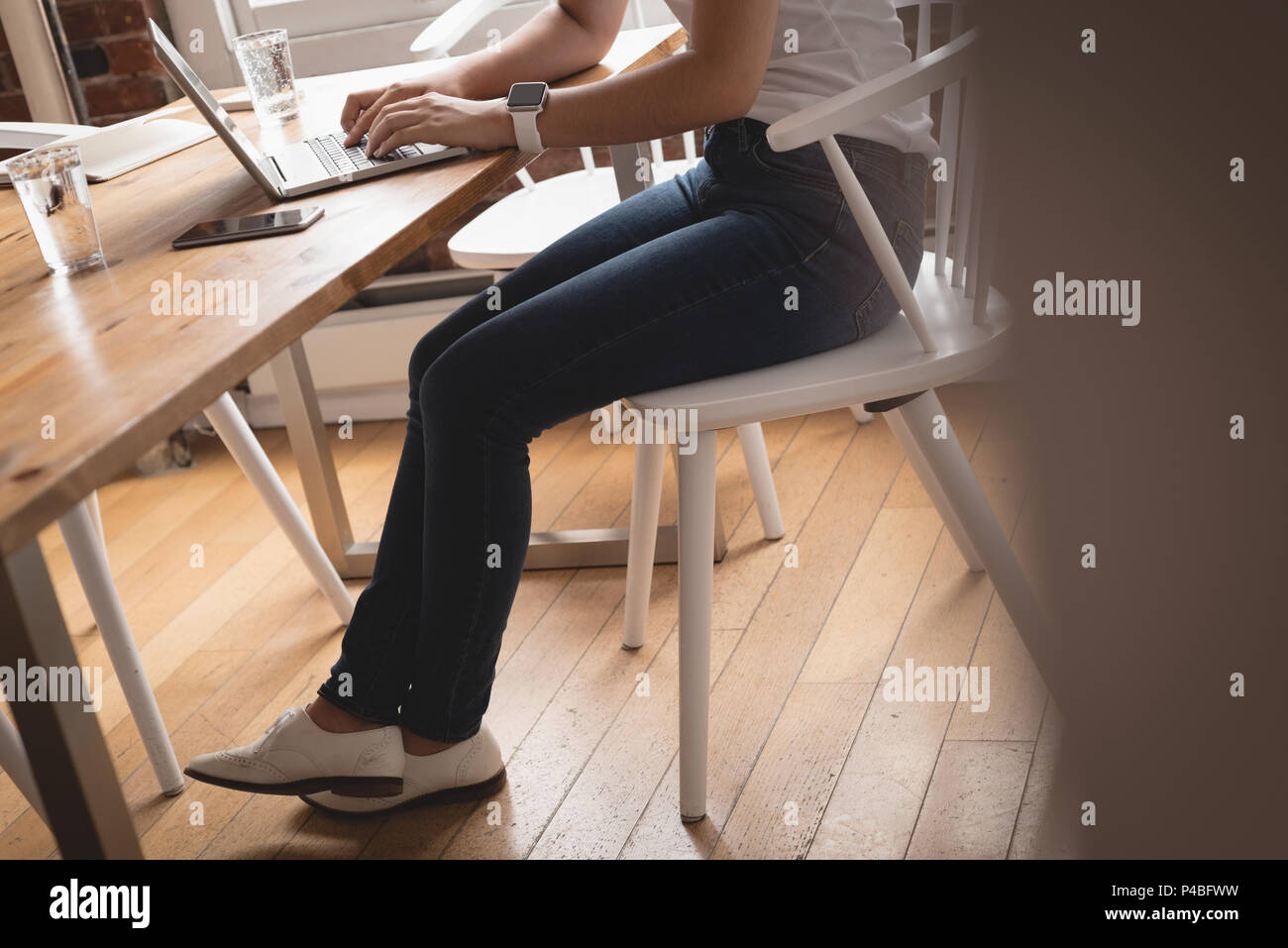 Female executive using laptop Stock Photo - Alamy